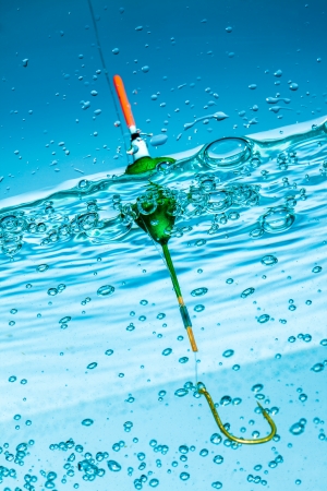 Fishing float against the blue background - Stock Image - Everypixel