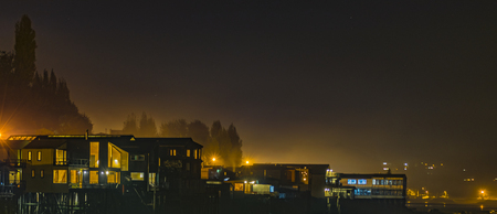 Night scene at typical palafito houses at lake in Castro city, Chiloe ...