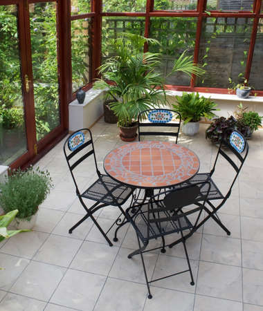 conservatory tables chairs plants room in house next to gardenの写真素材 ...