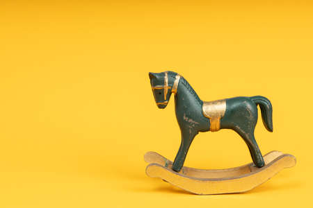 Blue vintage rocking horse on yellow background - Stock Image - Everypixel
