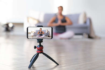 Yoga online to live streaming on a smartphone - fitness trainer teaches ...