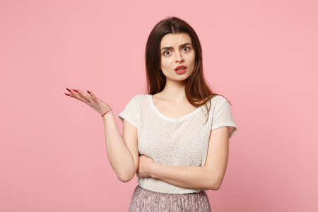 Perplexed concerned young woman in casual light clothes posing isolated ...