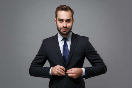 Young business man in classic black suit shirt tie posing isolated on ...