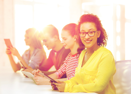 education, technology and internet concept - smiling female students ...