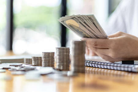 A woman counting her salary to separate expenses, she keeps a monthly ...