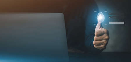Businessman with a laptop, hologram icon fingerprint encryption ...