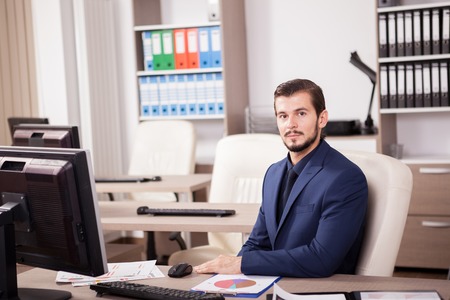 Young Businessman in suit working in his office. Business and corporate ...