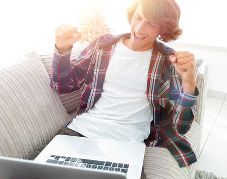 happy young man looking at laptop screen - Stock Image - Everypixel