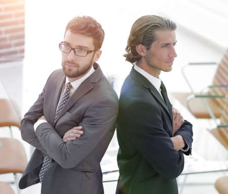 Two men standing back to back and support each other - Stock Image ...