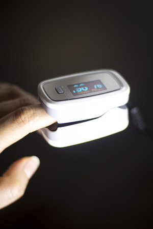 Portable hand held domestic cardiac finger pulse rate meter to show ...