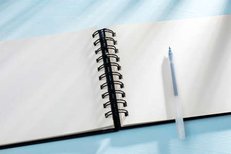 An open notebook on springs with white craft paper lies on a table ...