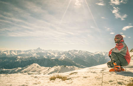 Alpinist on the mountain summit. Shot in backlight, stunning panoramic ...