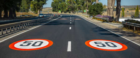 Close-up view of two 50 km per hour, speed limit signs painted on ...