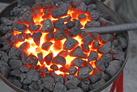 glowing lava in the grate of the blacksmith during the making of the ...