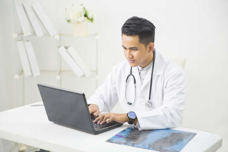 portrait of Medical doctor working with laptop in the office - Stock ...