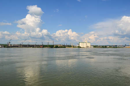 Romanian side of the Danube and industrial zone with cranes and silo ...