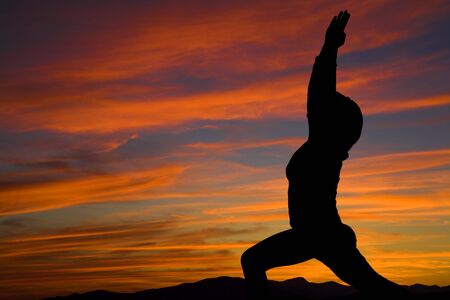 woman doing yoga over scenery sunset shot from english bay - Stock ...