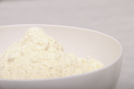 Some flour in a white bowl on light backgroundの素材 [FY31019015764 ...