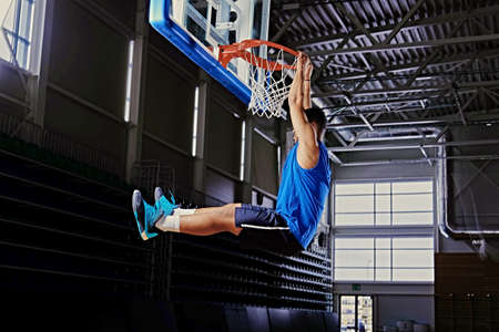 Black professional basketball player in action on a basketball field ...