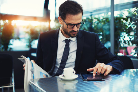 Handsome young businessman use digital tablet pressing the button and ...