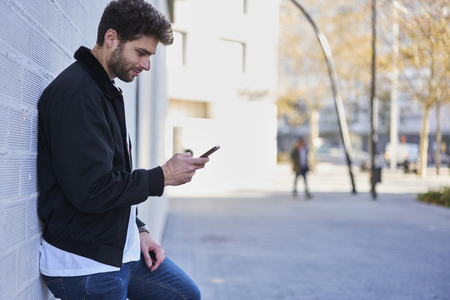Young male blogger concentrated on reading comments under traveling ...