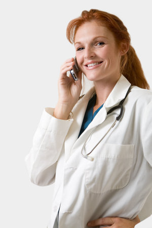 Female attractive doctor with red hair tied back in a ponytail wearing ...