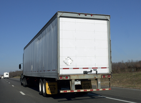 Rear view of semi trailer on highway. - Stock Image - Everypixel