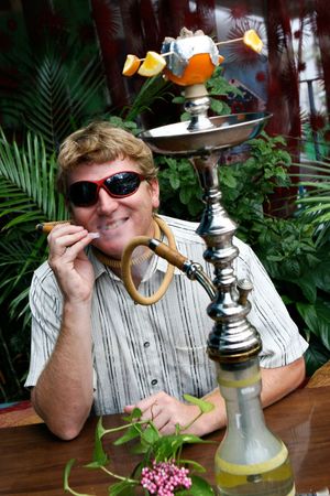 Man smoking a traditional Middle Eastern Hookah.の写真素材 [40004613106]｜毎月1 ...