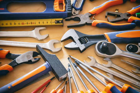 Home repair tools set on wooden background. DIY, maintenance service ...