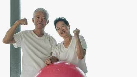 Happy old senior Asian couple have fun with gym yoga ball class - Stock ...