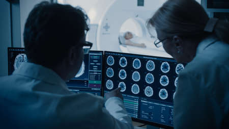 In Control Room Doctor and Radiologist Discuss Diagnosis while Watching ...