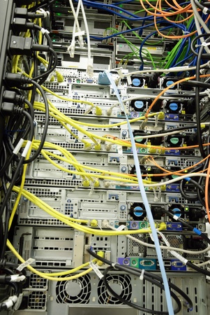 Picture of an messy backside of server rack. - Stock Image - Everypixel