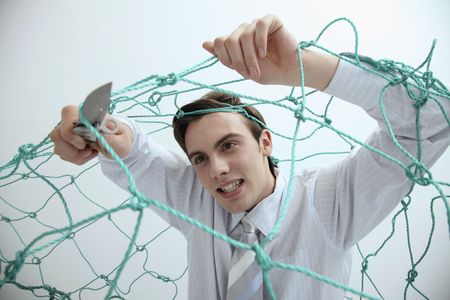 Man trying to escape from being trapped under net with a knife - Stock ...