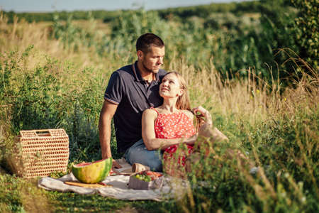 Young couple in love on summer picnic with watermelon. Loving couple ...