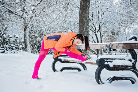 Winter workout, Winter fitness, exercising in cold weather. Sportswoman ...