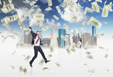 businessman in a suit jumping on clouds happily with his hand up, money ...