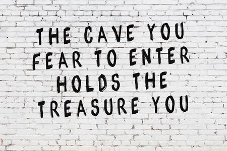 White brick wall with painted black motivational quote inscription ...