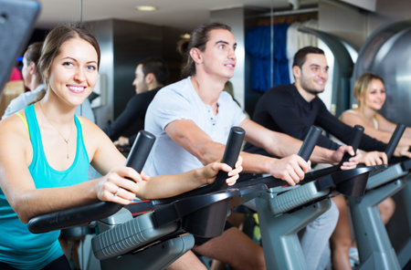 Smiling group of active people training on treadmills in gym - Stock ...