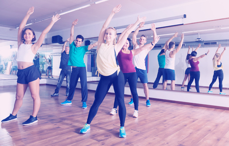 Laughing positive people learning steps in dance hall - Stock Image ...