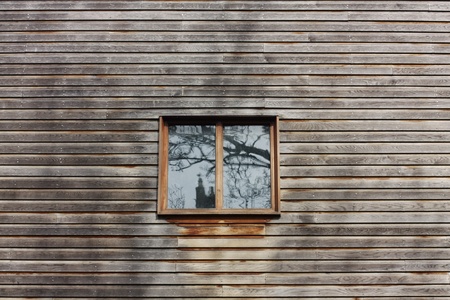 wooden house with shadow glass window in the middleの写真素材 [40009387801 ...