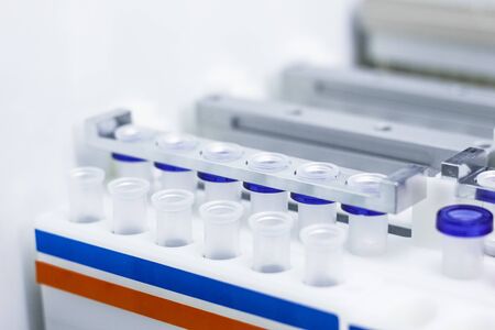 Detail of a laboratory device, with rows of tubes and metallic and ...