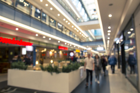 People and buyers go inside a large shopping mall, a lot of shops and ...