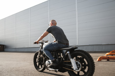 Handsome rider guy with beard and mustache ridding on classic style ...
