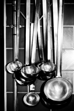 Ladles hanging in a Commercial Kitchenの写真素材 [40010024885] - イメージマート