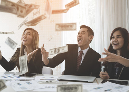 Business team parter celebrating profit by throwing money - Stock Image ...