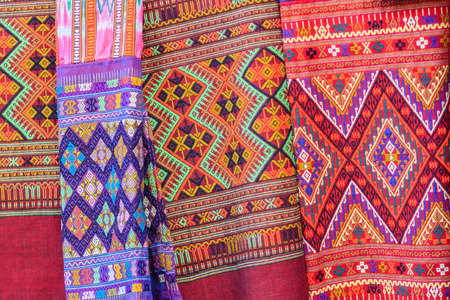 Colorful of native thai style silk and textiles pattern. Beautiful handmade woven fabrics thai silk fabric textured with different native style