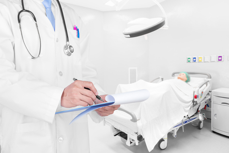 Doctor writing a medical prescription in delivery room - Stock Image ...