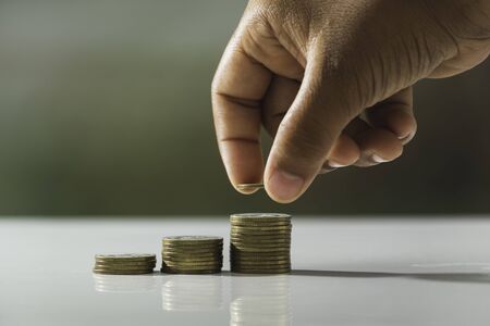 Hand drop a coin with money coin stack growing for business. financial ...