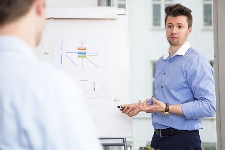 Executive Explaining Presentation To Colleague In Office - Stock Image ...