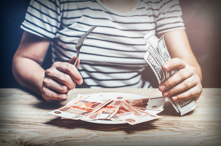 In the hand fork, on a plate money, metaphor, money for food - Stock ...